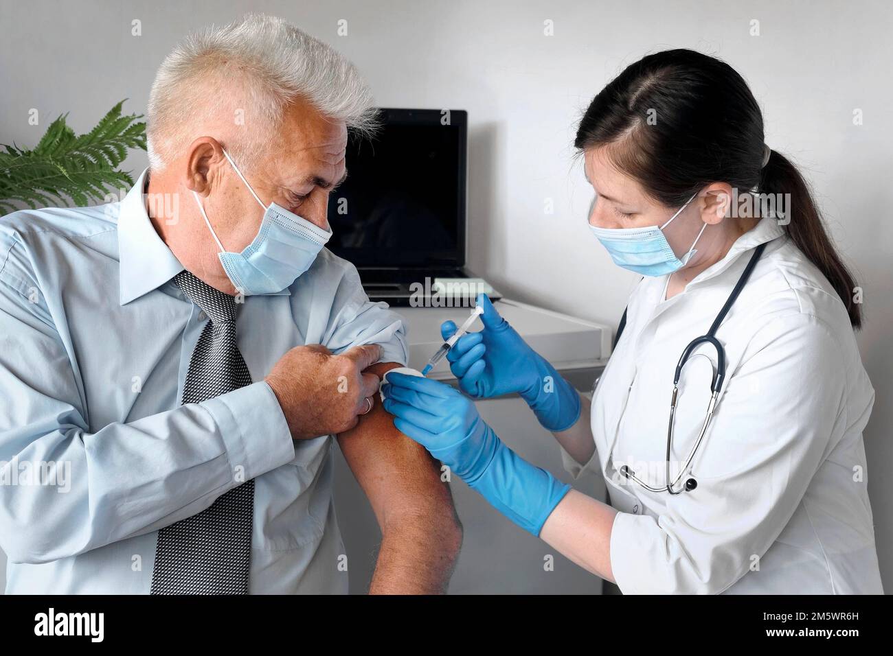 Doctor Vaccinating Senior Man In Clinic. Older People Vaccination ...