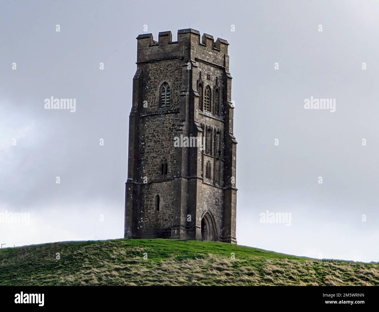 The Glastonbury Tor hill topped by the roofless St Michael's Tower in ...