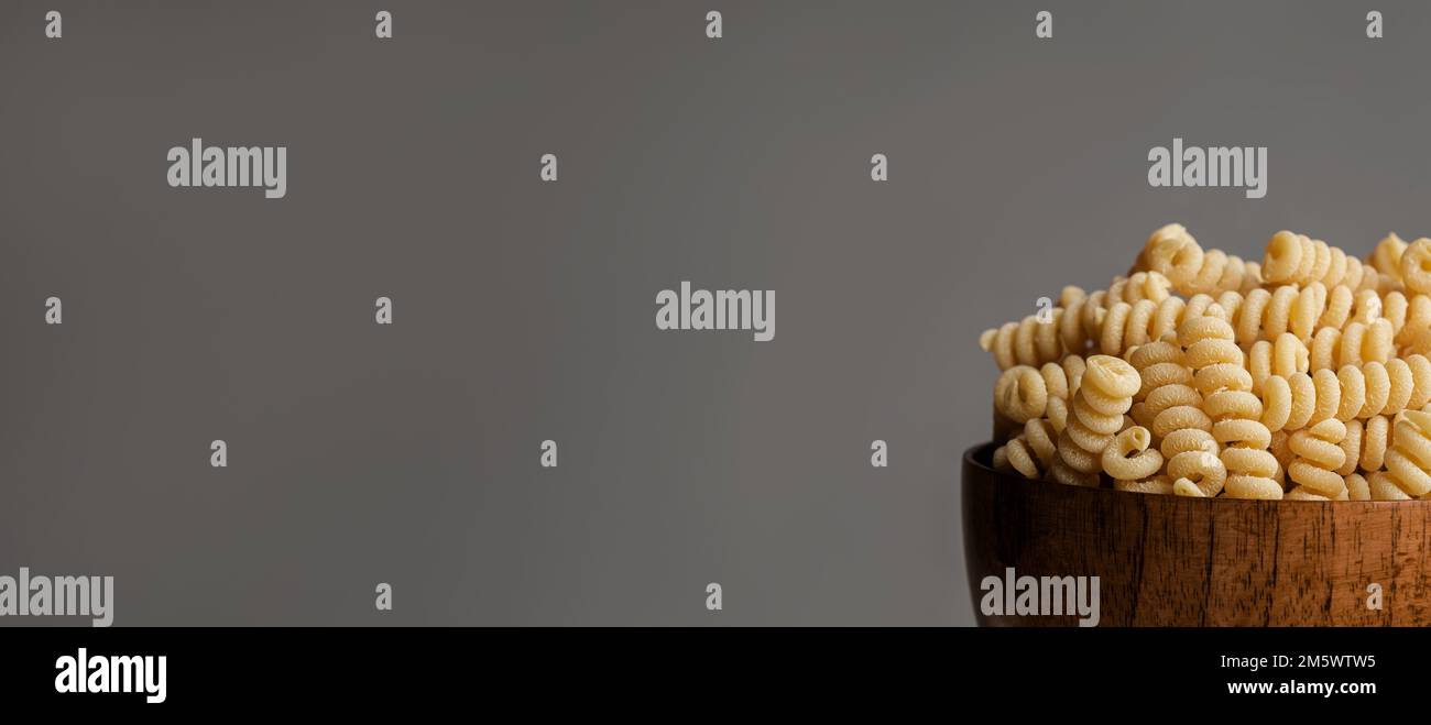 Gluten Free Cornmeal Pasta in wooden Bowl. Spiral Raw Macaroni from ...