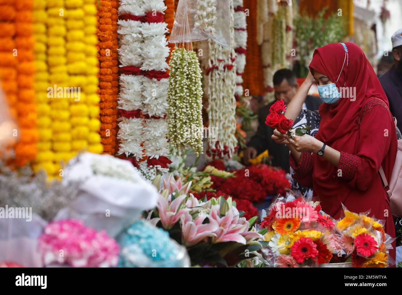 Dhaka, Bangladesh - December 31, 2022: Many people come at Shahbagh in Dhaka to buy flowers at ...