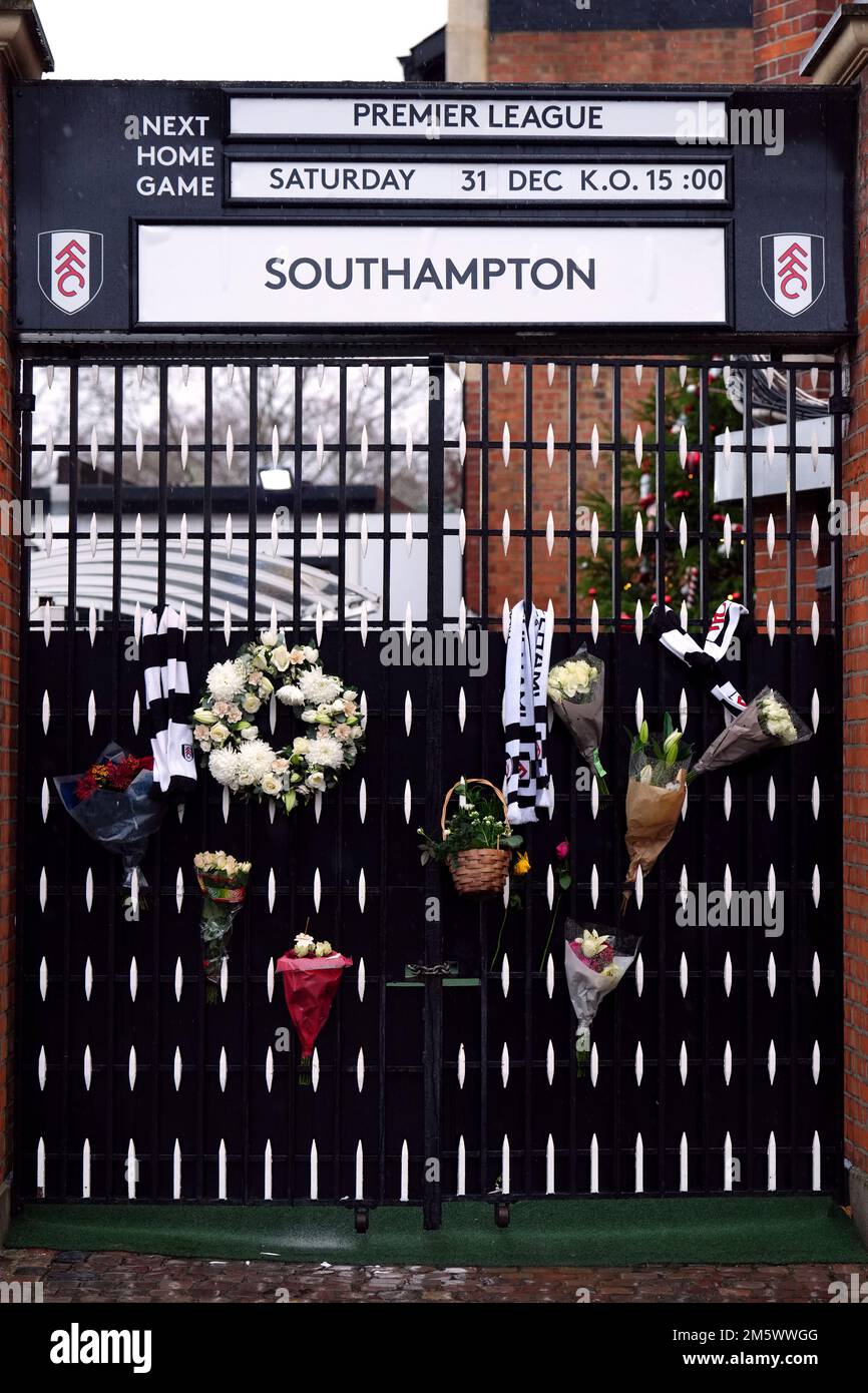 Floral tributes on a gate at the ground for former Fulham player George ...