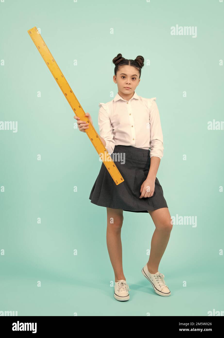 Teenager child school girl holding measure for geometry lesson ...
