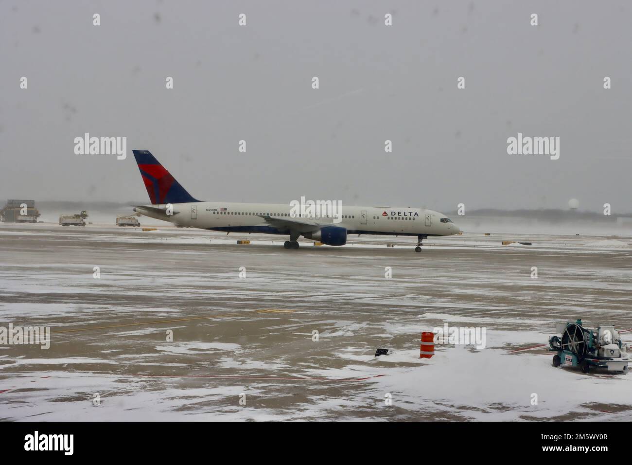 Arriving Delta airlines jet at snow-covered Cleveland Hopkins airport ...