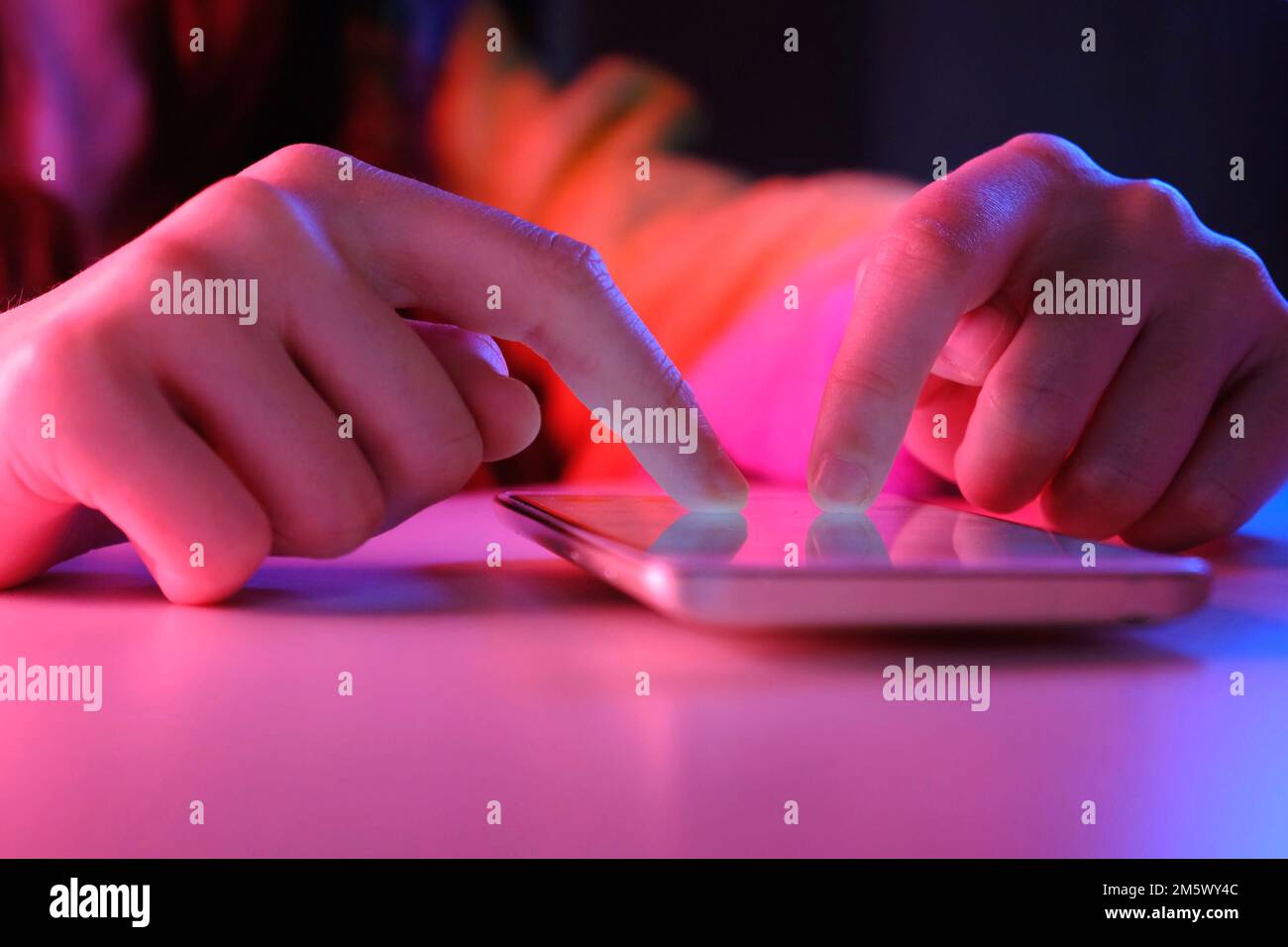 Use of mobile phone in trendy neon lights. Creative vivid color of ...