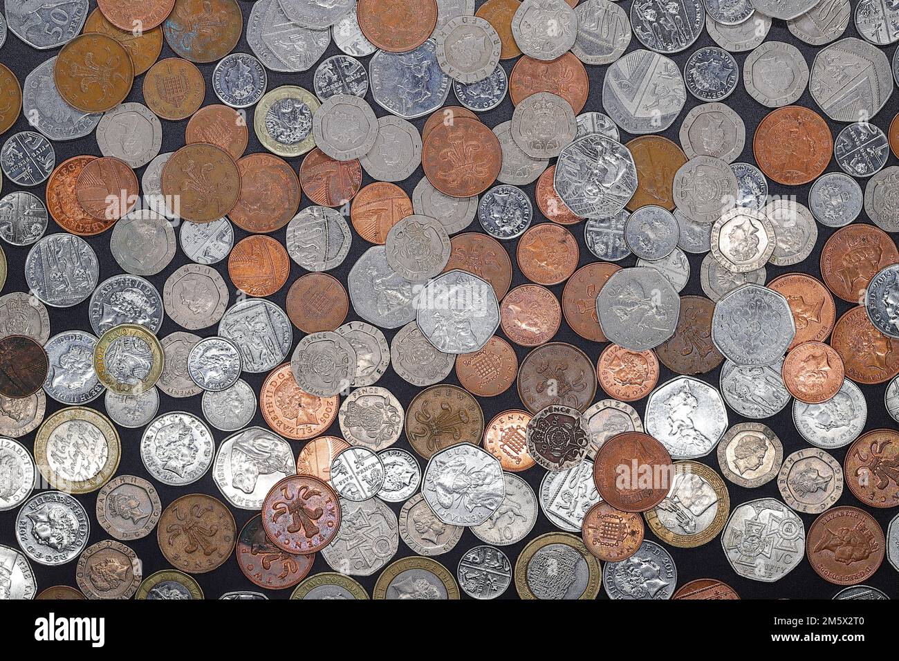 A pile of British coins including 1 pence, 2 pence, 5 pence, 10 pence ...
