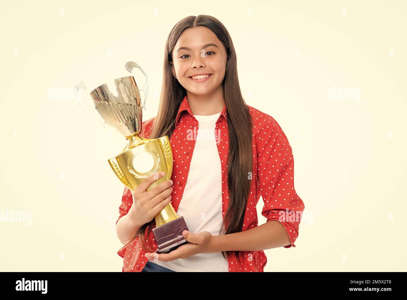Teenage girl holding a trophy. Kid winner child won the competition ...