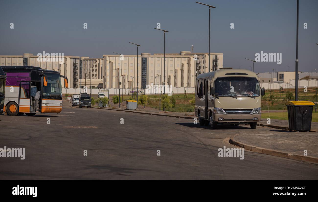 Buses or autobuses parked on a parking in front of residental block in ...