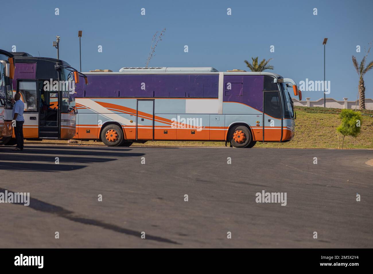 Buses or autobuses parked on a parking in front of residental block in ...