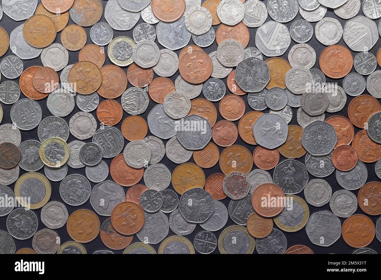 A pile of British coins including 1 pence, 2 pence, 5 pence, 10 pence ...