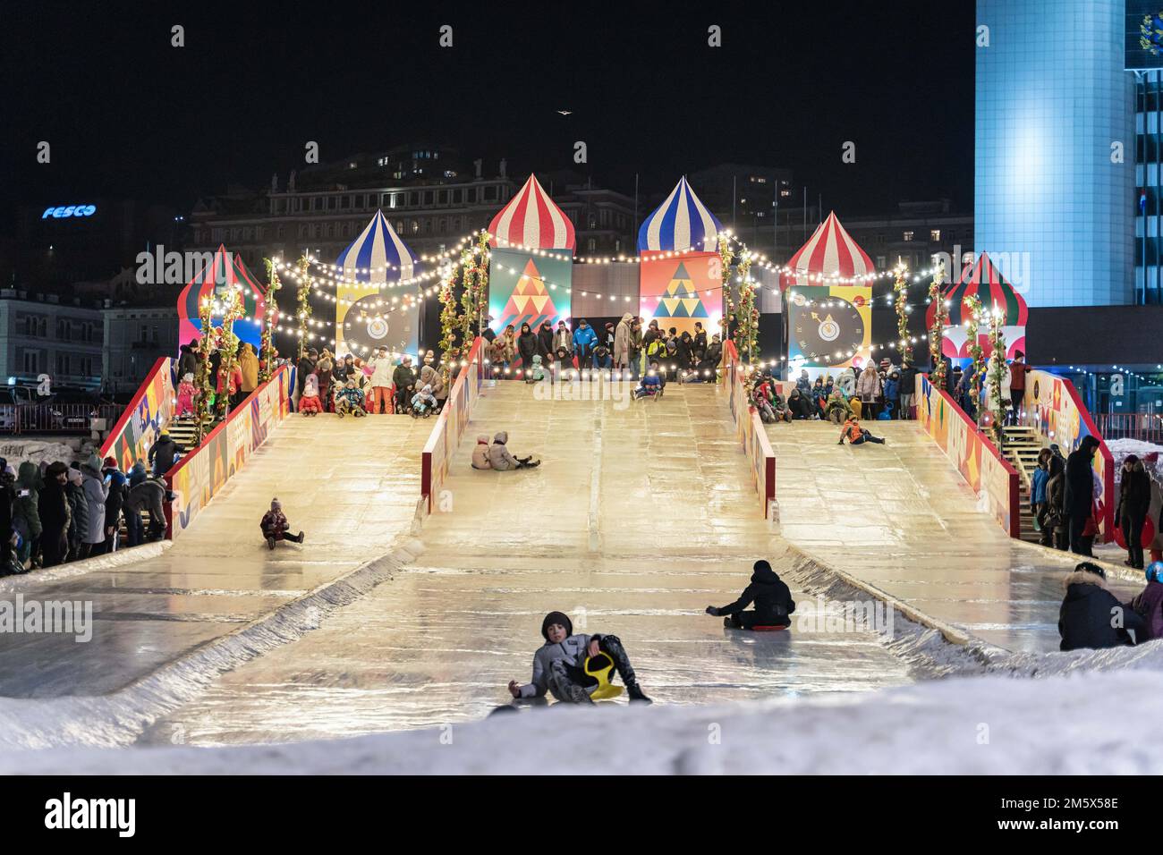 Vladivostok, Russia. 31st Dec, 2022. People play on ice slides in the ...