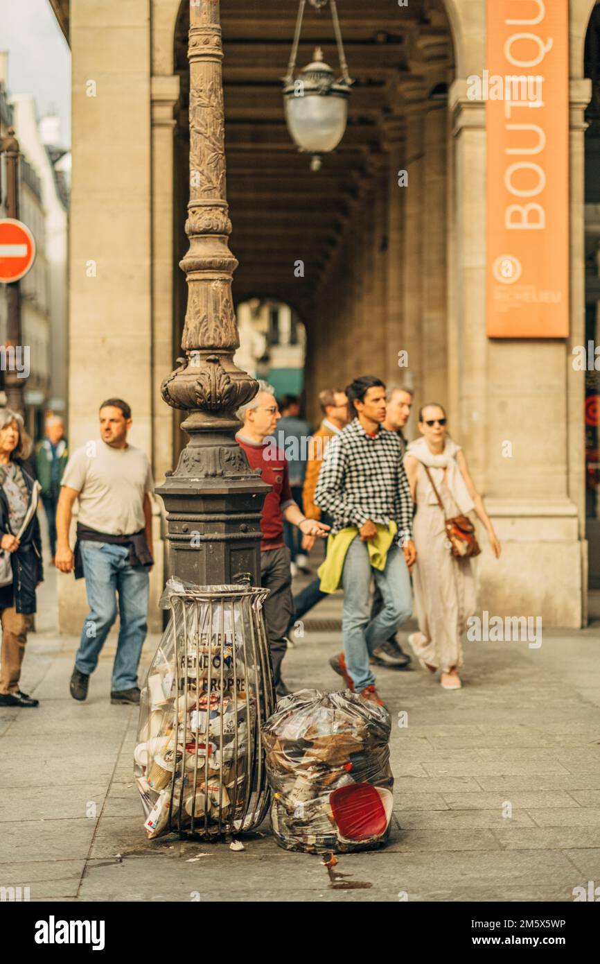 A vertical shot of the city life with trash bags in the streets of ...