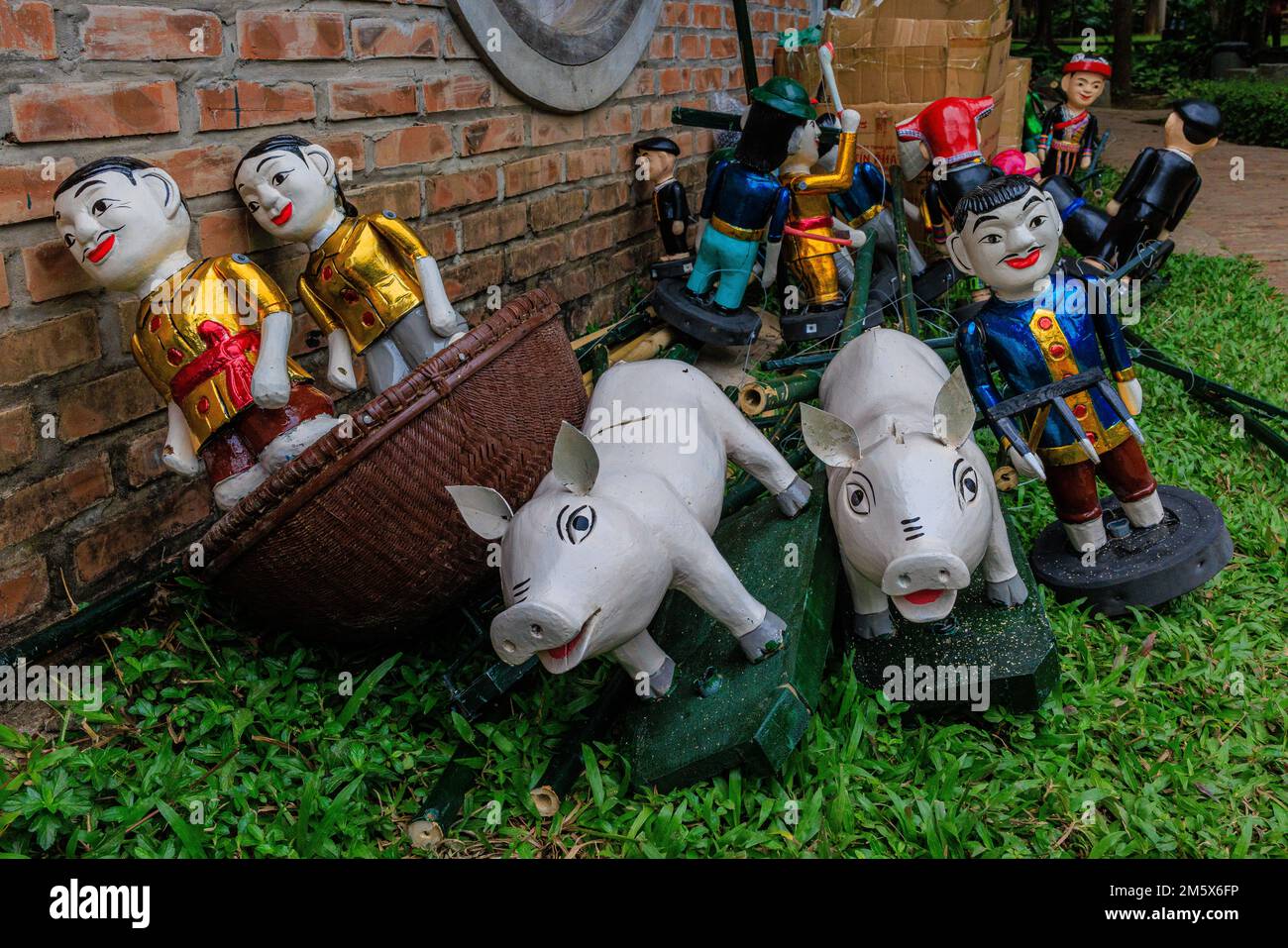 many colourful water puppets on floats and attached to poles and ropes ...