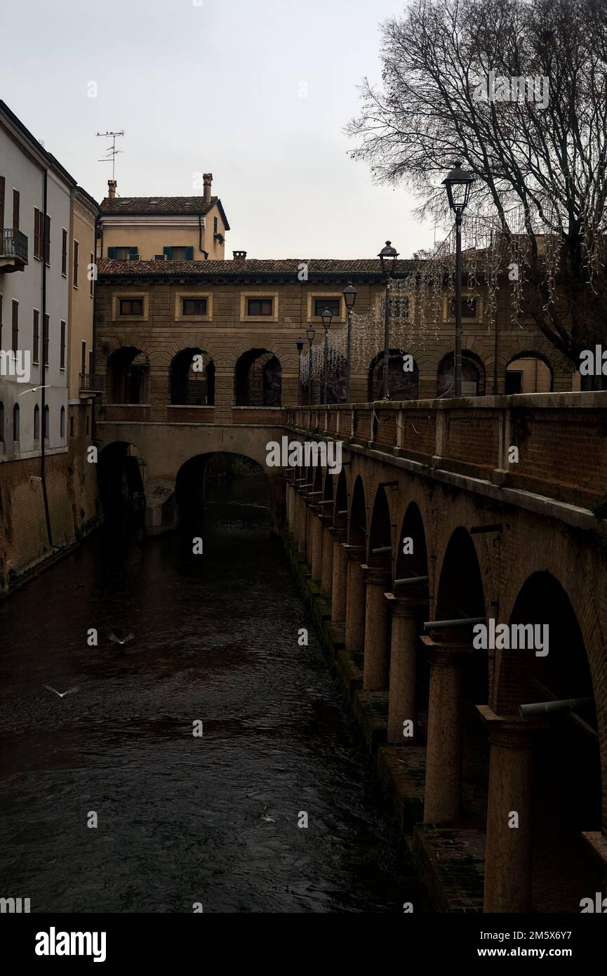 River In a town with an ancient porchway below street level on a cloudy ...