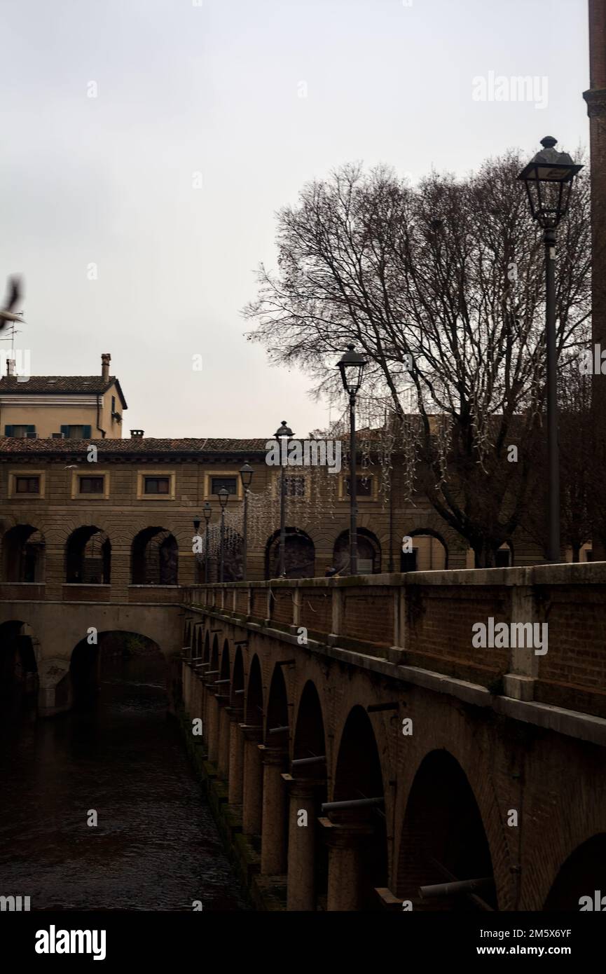 River In a town with an ancient porchway below street level on a cloudy ...