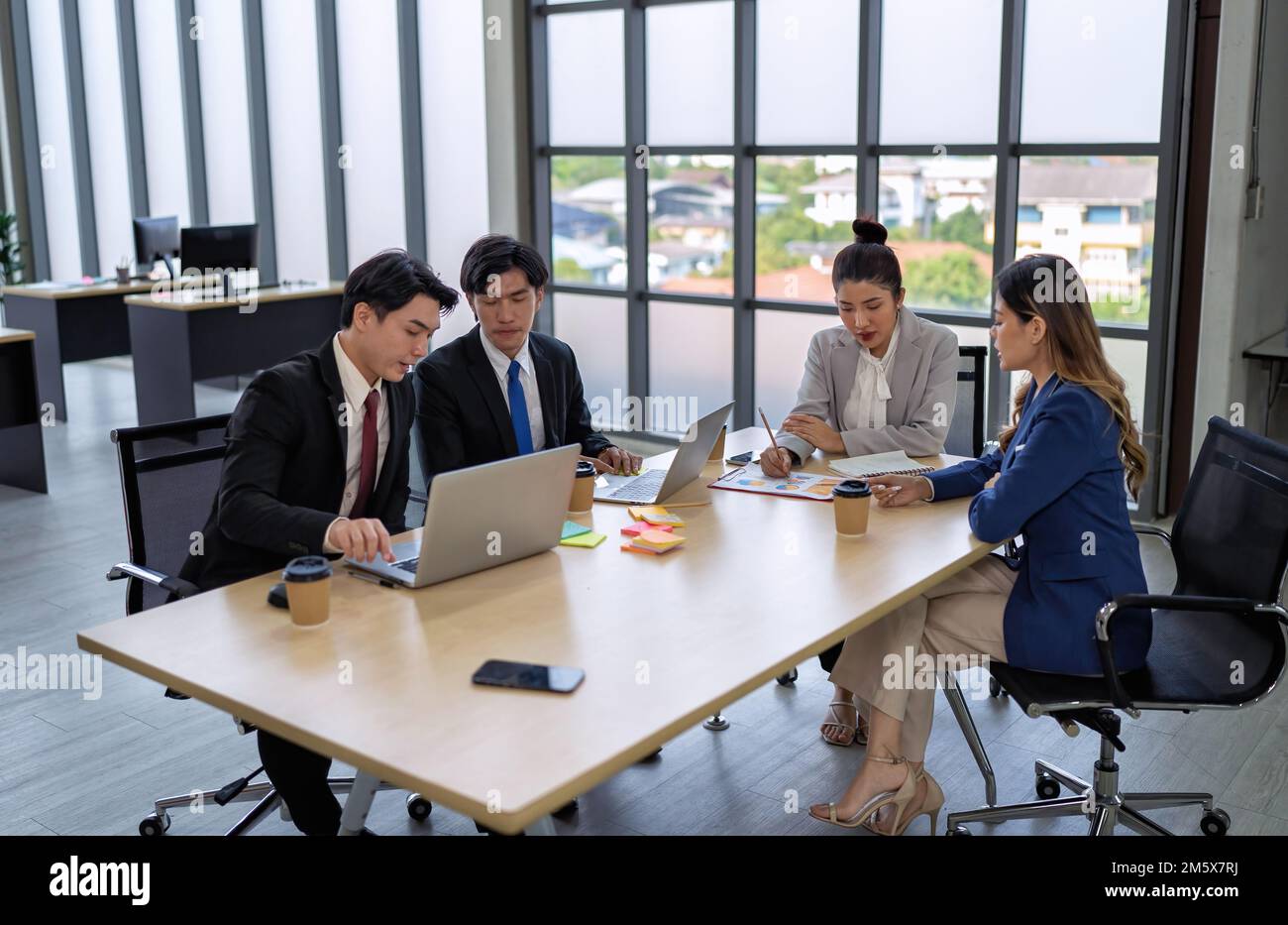 Business meeting of business people in office formal wear sitting at ...