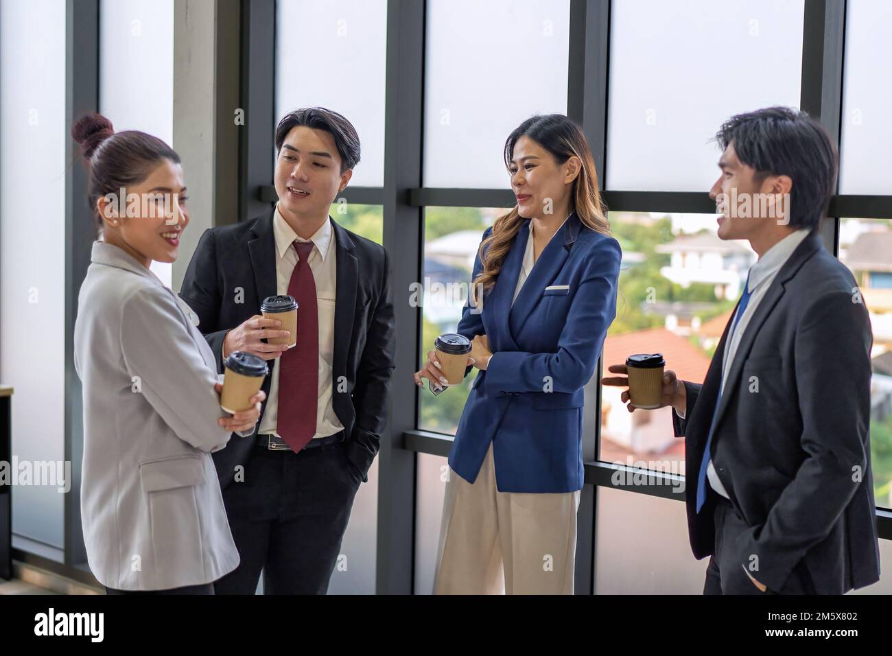Business meeting of business people in office formal wear stand hold ...