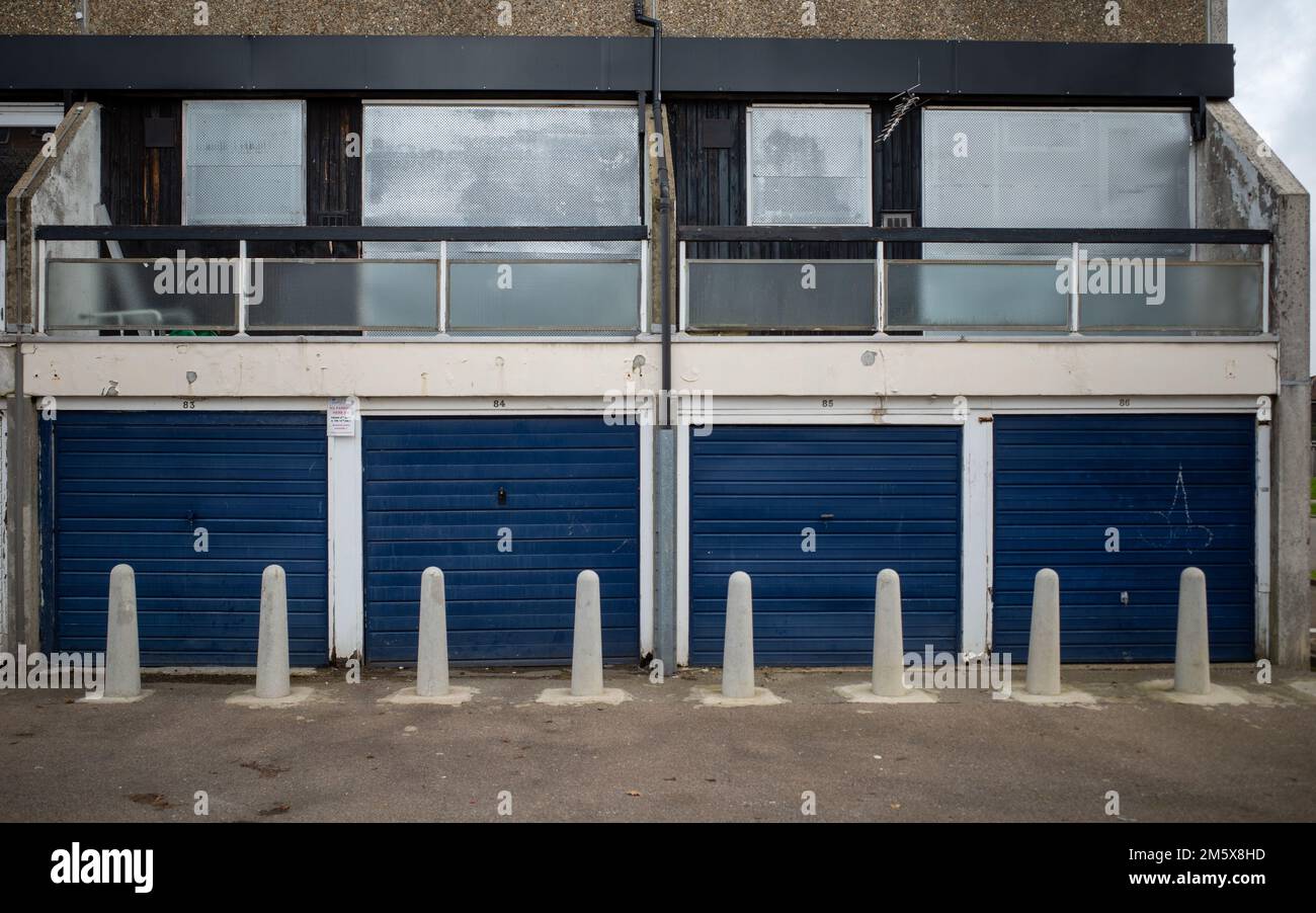 Boarded up flats and garages in run down housing estate, North London ...