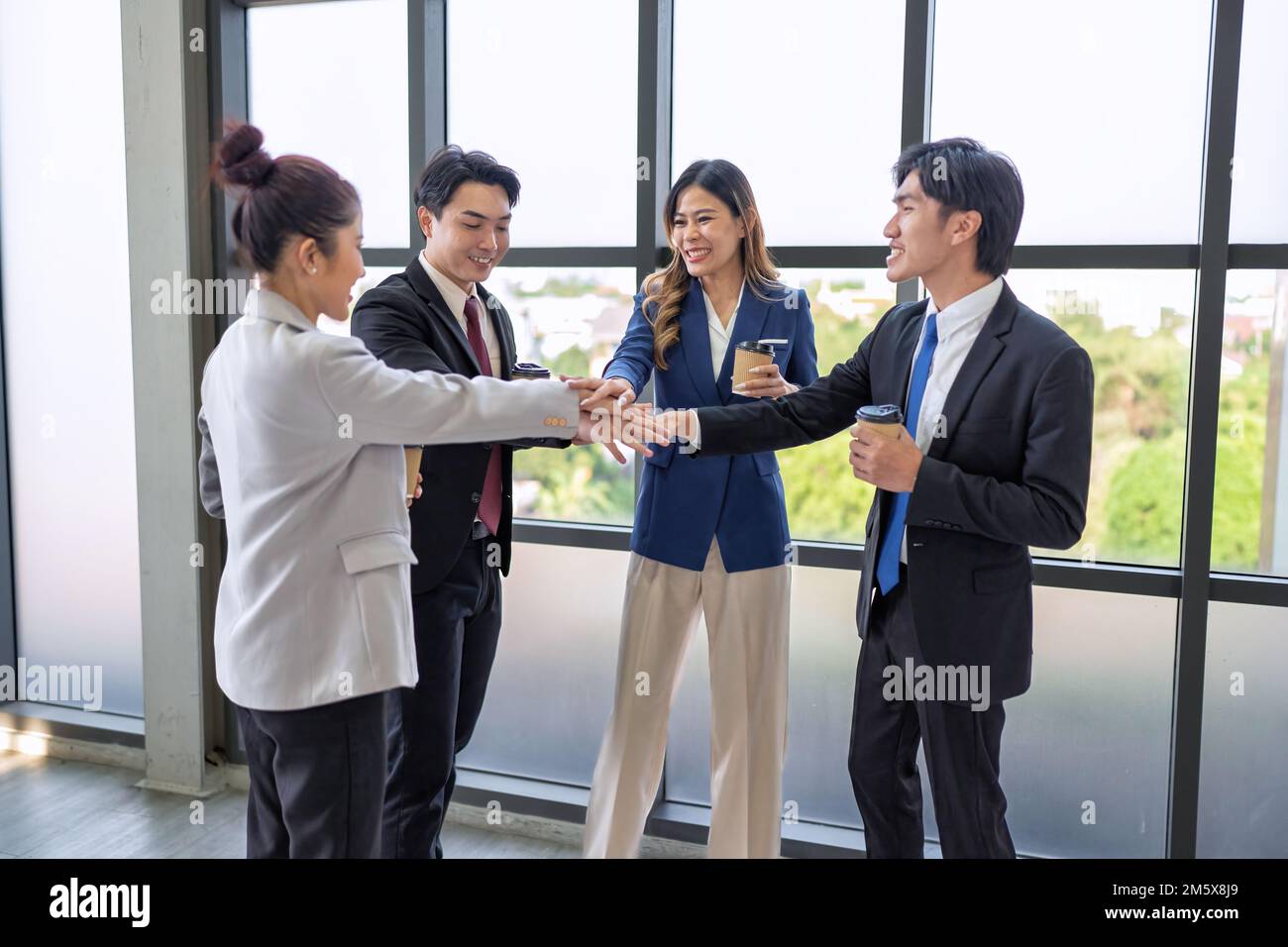 Business people in office formal wear stand hold glass of coffee on ...