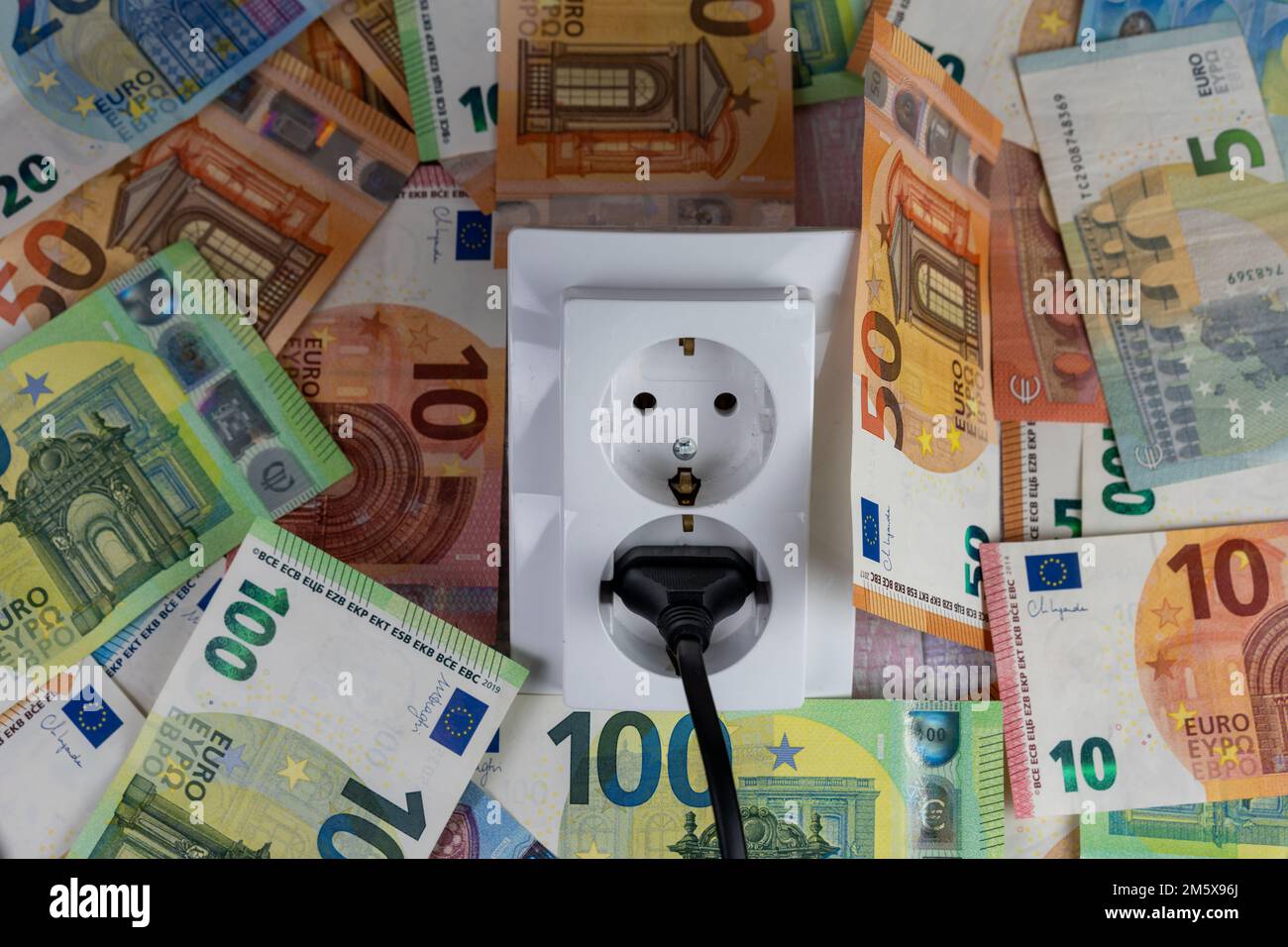 An Electric plug on the on Euro banknote money, electricity prices ...