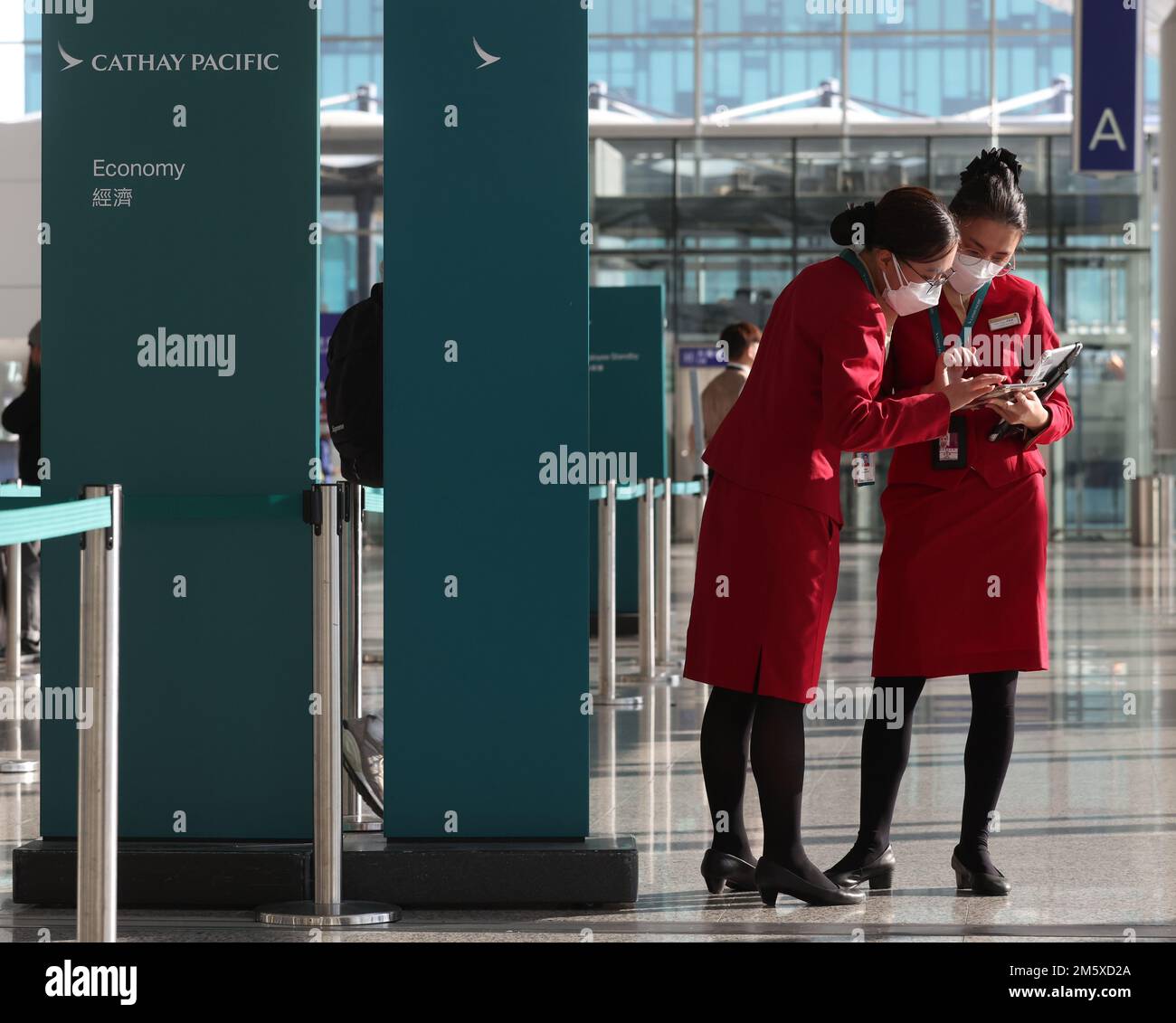 Cathay Pacific Airway (CX) ground crew work at the departures hall at ...