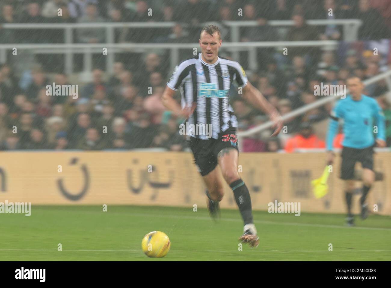 Dan Burn #33 of Newcastle United runs with the ball during the Premier ...