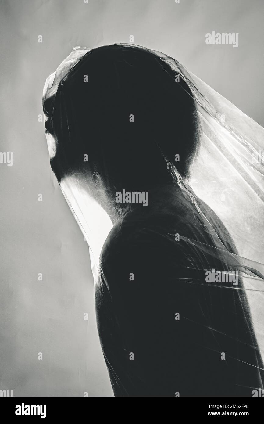 A vertical greyscale of a girl expressing her anger by shouting while ...