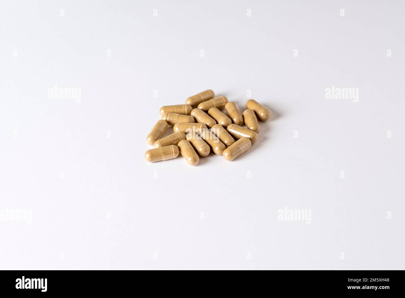 Vitamin K pills scattered on white background. Drug capsule pills with ...