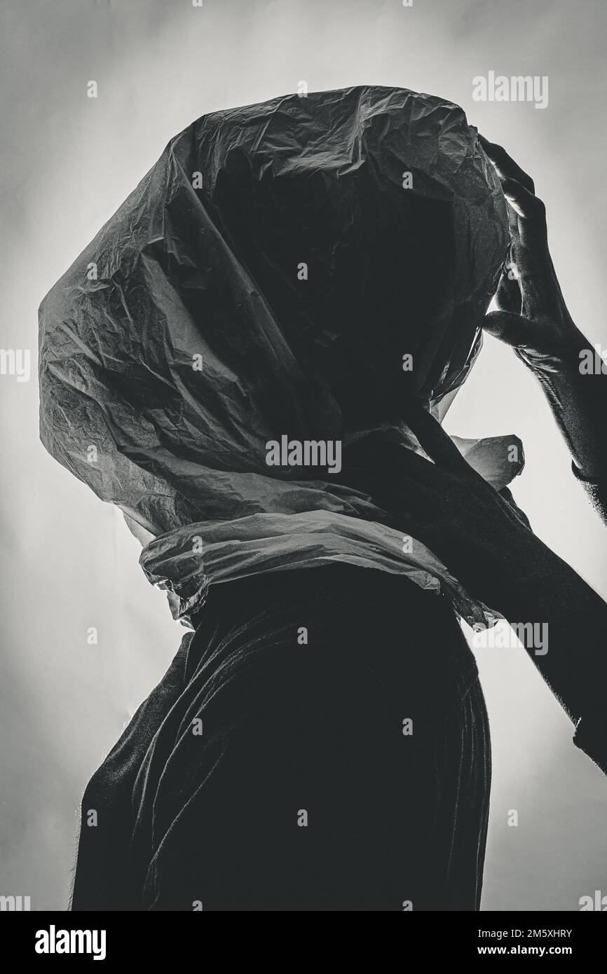 A vertical greyscale of a suffocating person blocked their head from ...