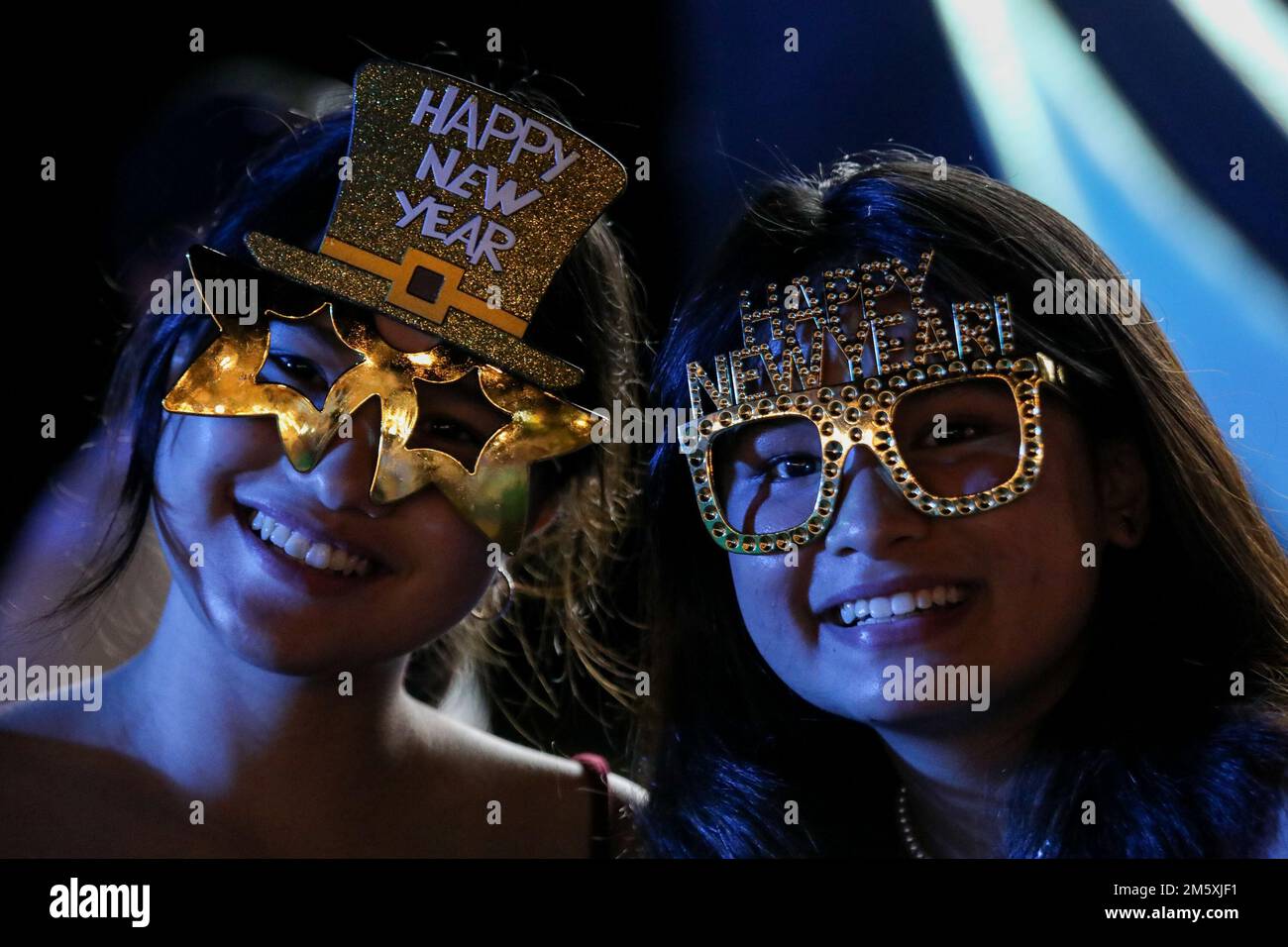 Manila, Philippines. 1st Jan, 2023. Women wear themed glasses during a ...