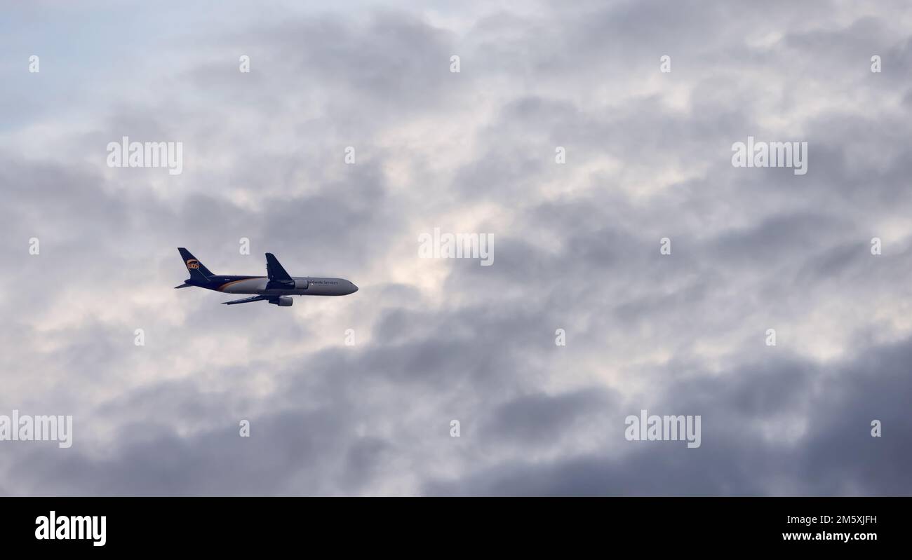 UPS Airplane flying in the sky during cloudy morning Stock Photo - Alamy