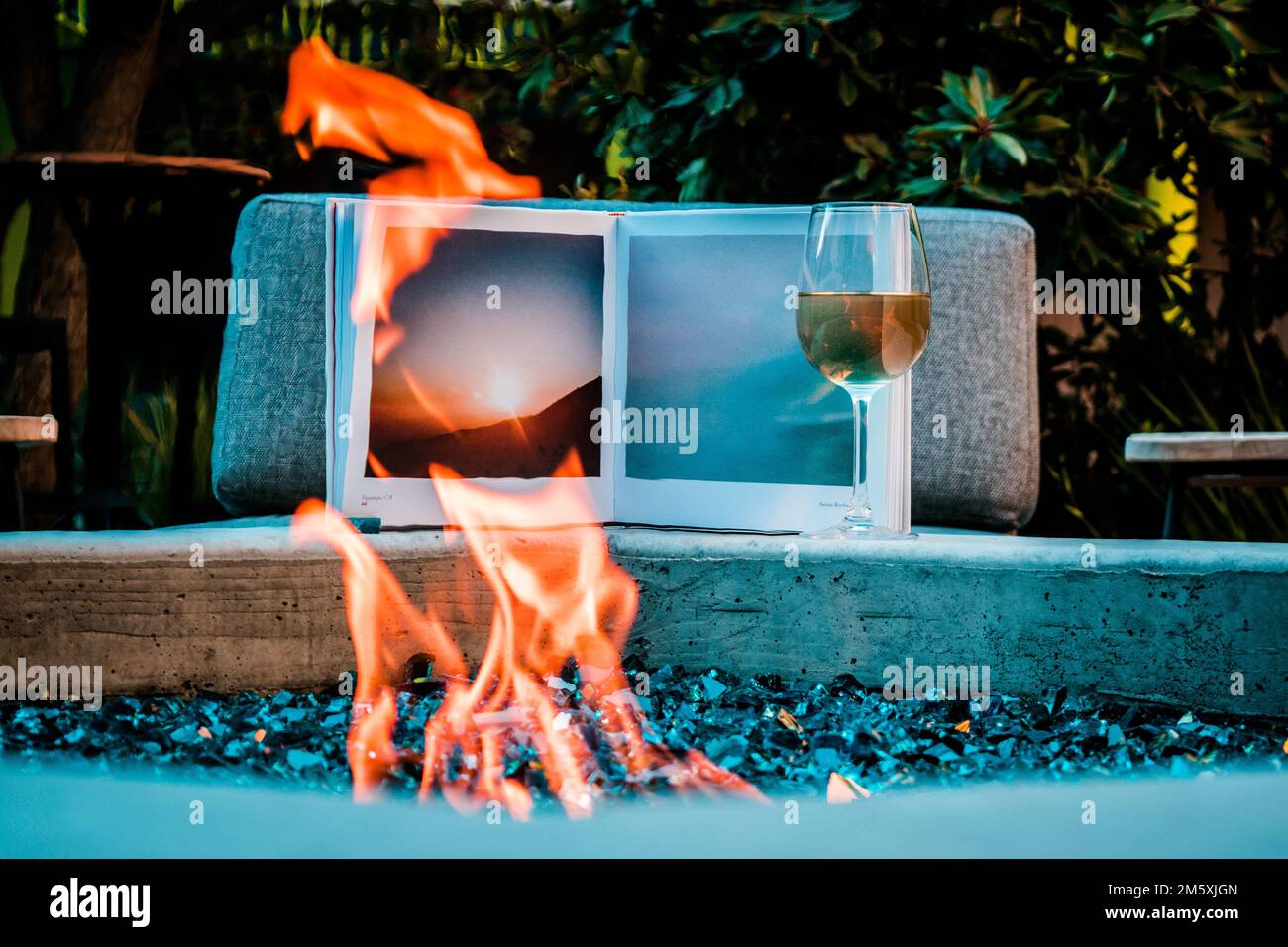 A fire in a bonfire in the courtyard of the house with wine on the ...