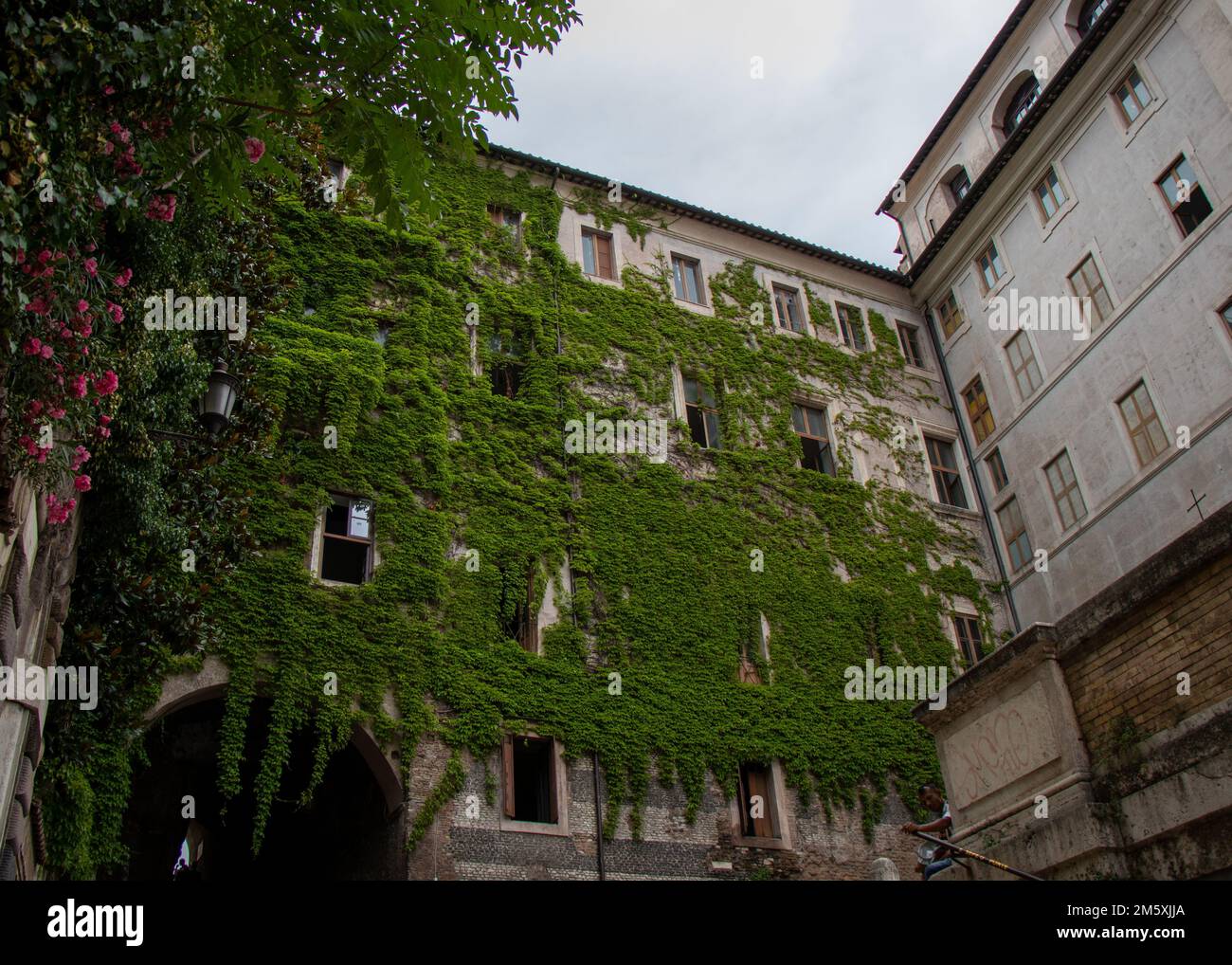 The urban apartment building covered with green plants, Rome, Italy ...