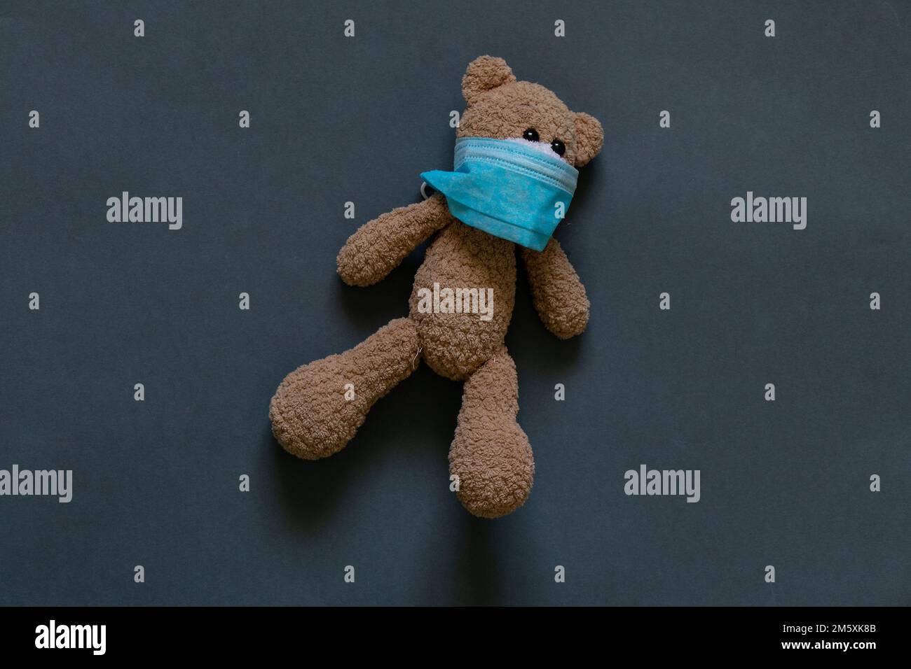baby brown teddy bear and medical mask during a pandemic Stock Photo ...