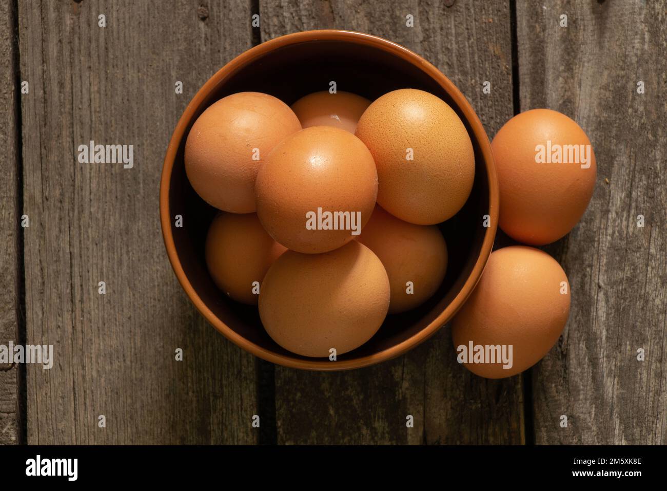 yellow chicken eggs on wooden table table Stock Photo - Alamy