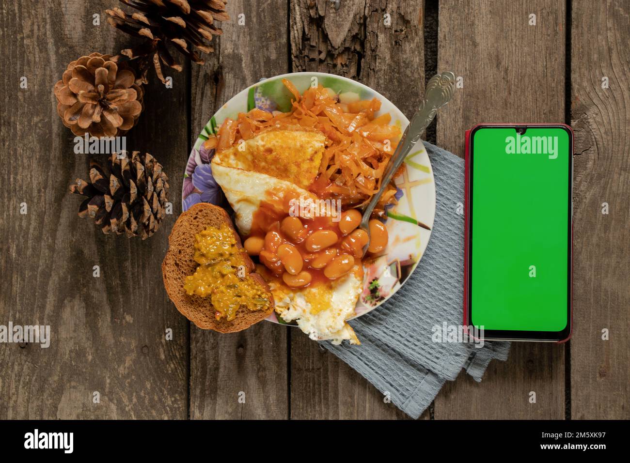 lunch plate with fried egg and salad and a phone with a green screen ...