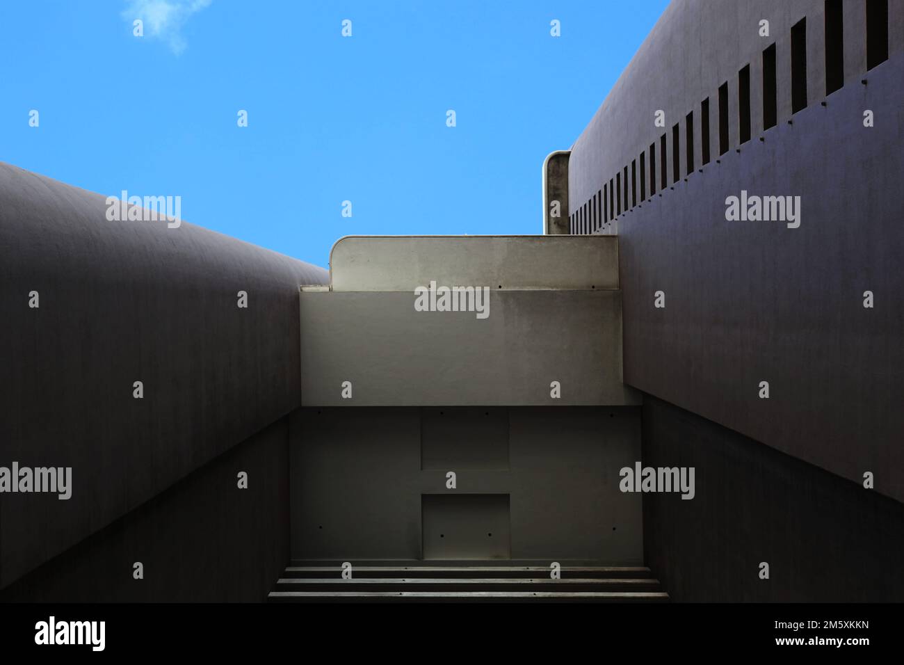 A view from below, offset cement and concrete high rise building bottom ...