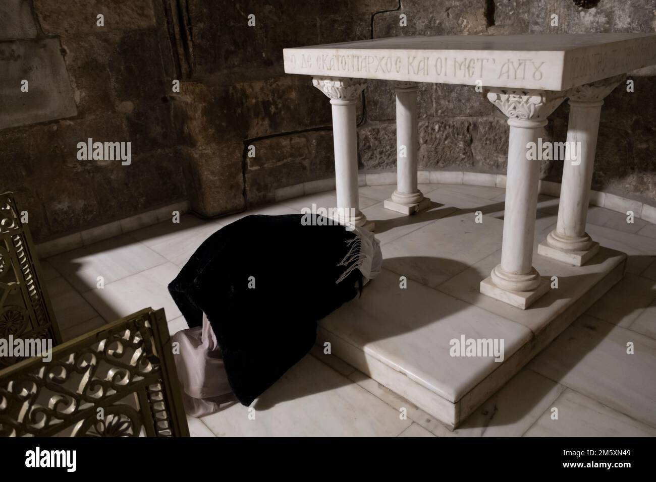 A Christian pilgrim from Africa kneels in prayer at the Greek Chapel of ...