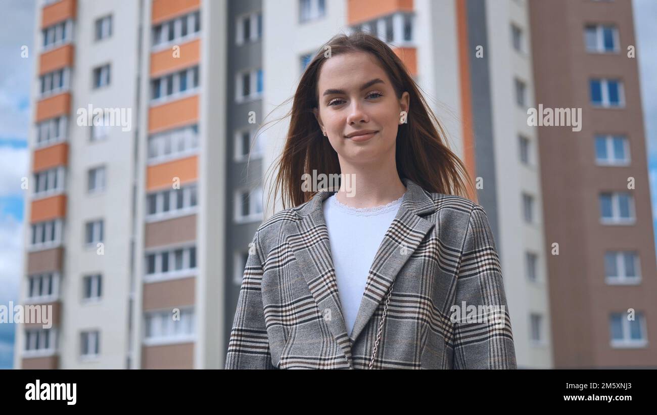 Portrait of a girl in front of a high-rise apartment building Stock ...