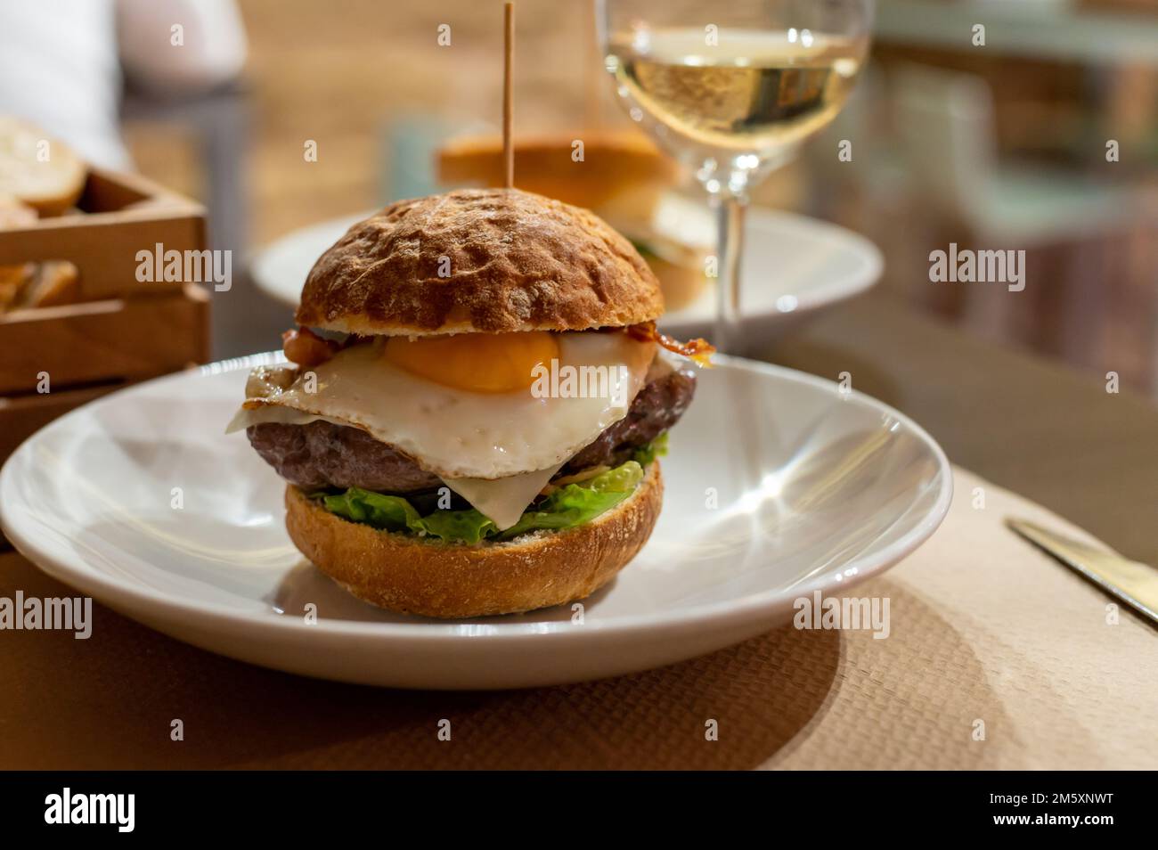 Tasty burger made with white crispy ban, beef burger, egg, green ...