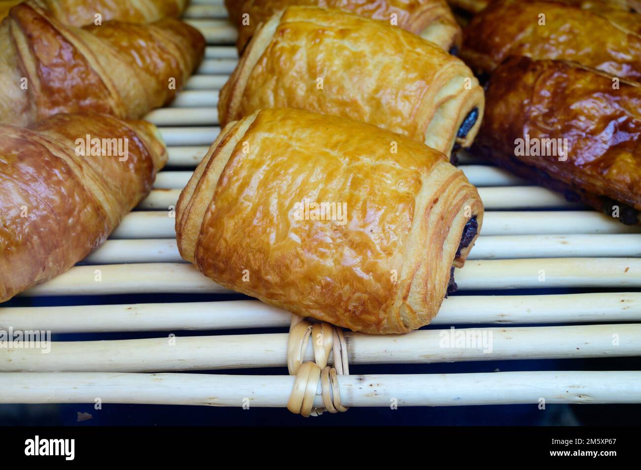 French bakery, fresh baked sweet buns and rolls on display in small ...