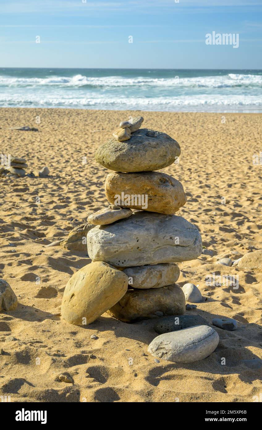 Pyramid from stack balanced stones on sandy beach in sunset, Atlantic ...