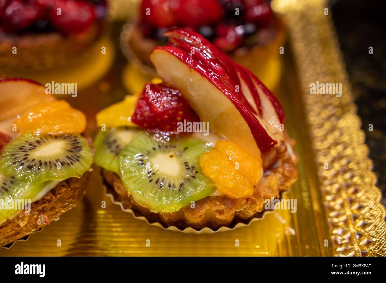 Delicious fresh baked colorful decorated cakes, tarts with cream and ...