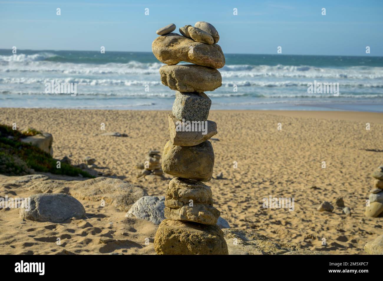 Pyramid from stack balanced stones on sandy beach in sunset, Atlantic ...