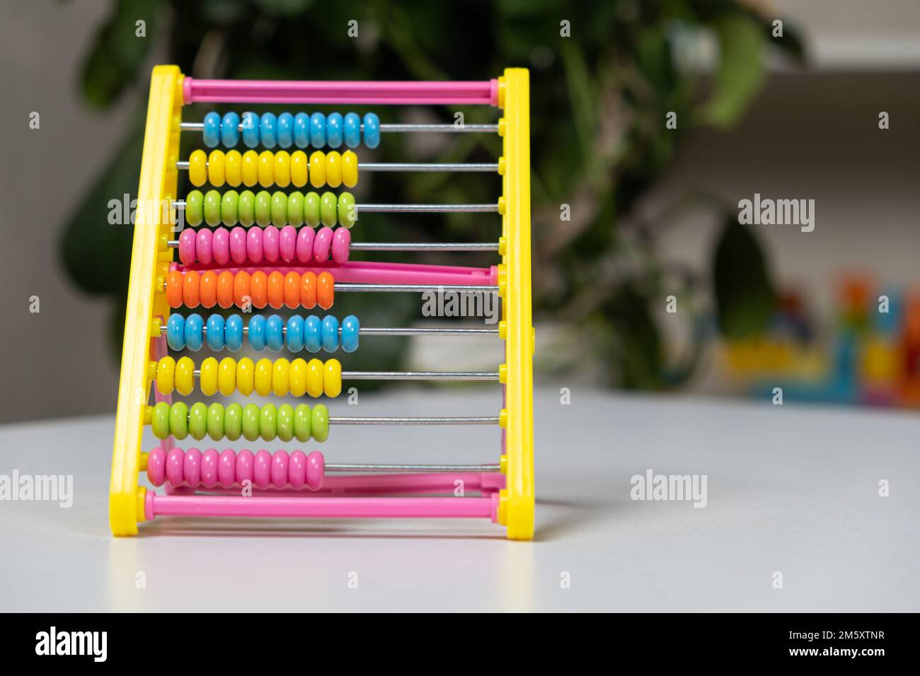 Colorful children's abacus on the table. Mathematics, arithmetic for ...
