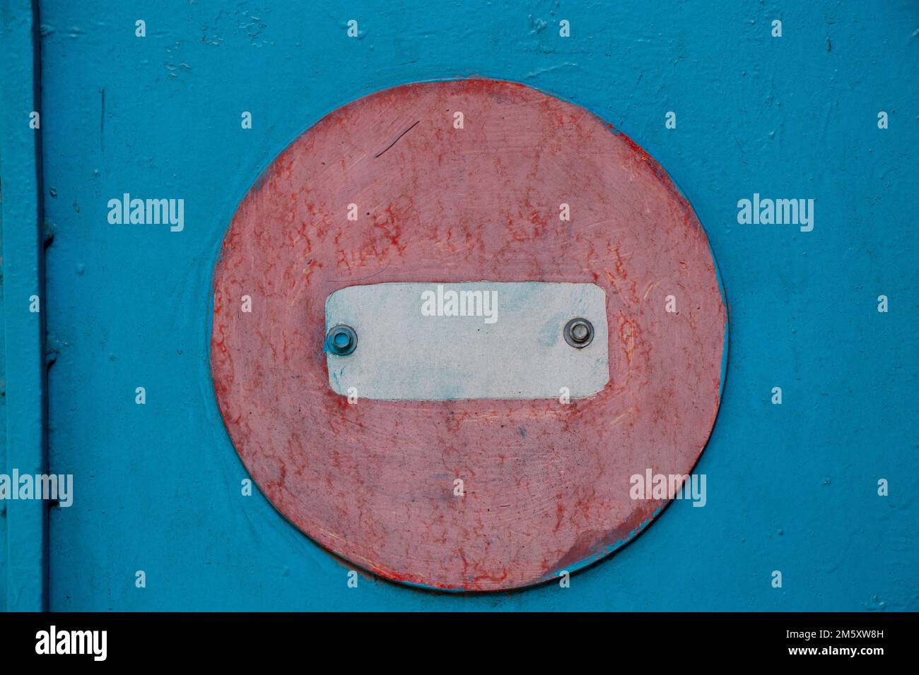 Old road sign is prohibited to enter on a blue background on the street ...