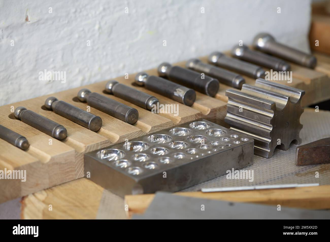 A closeup of metal tools of various sizes for punching holes in a ...