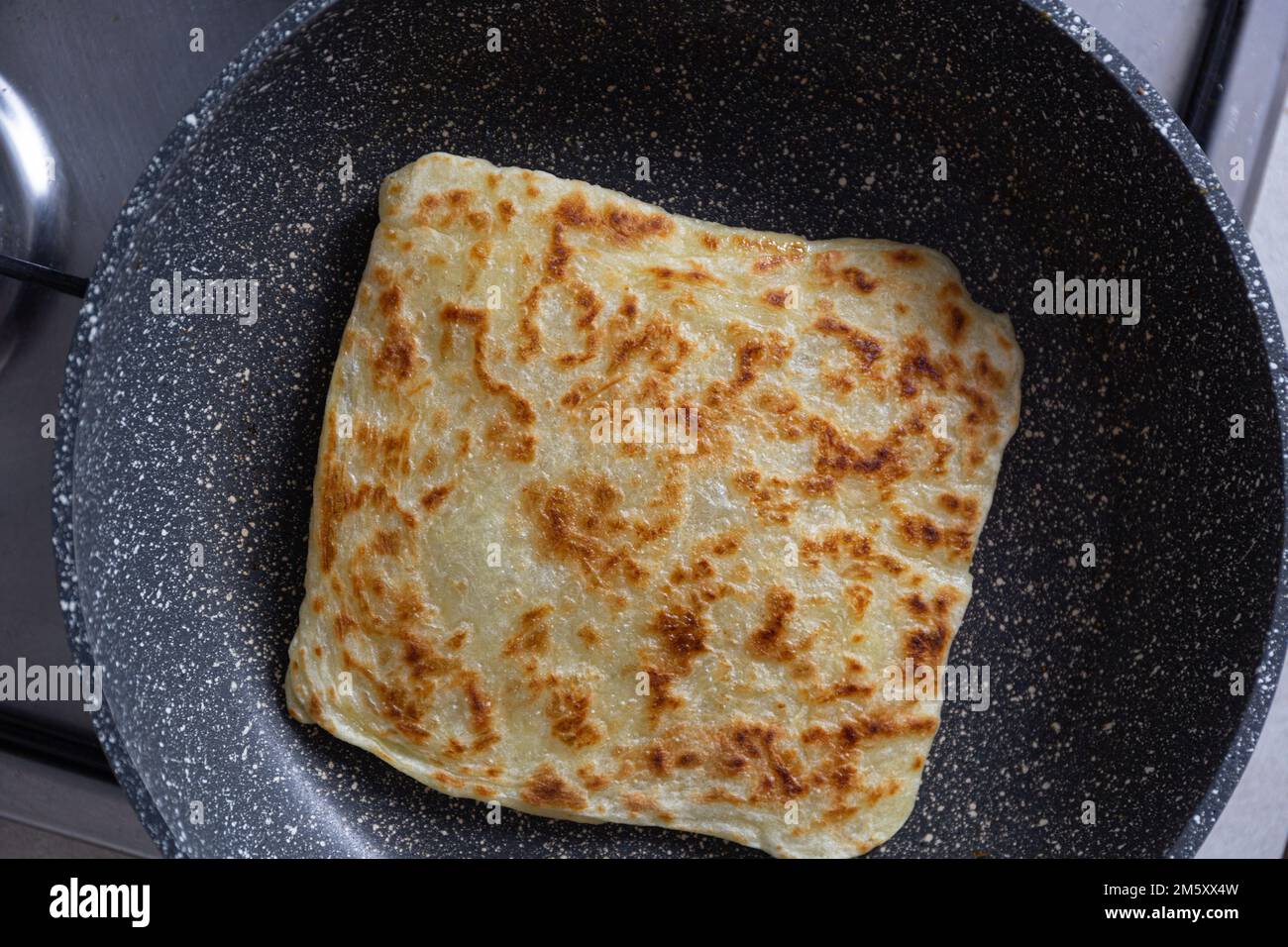 Moroccan Msemen flaky bread in the pan Stock Photo - Alamy