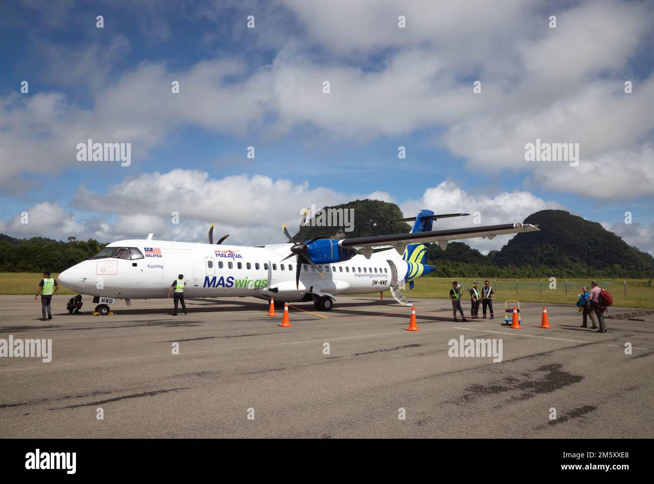 MAS Wings aircraft and passengers boarding at Mulu airport, Sarawak ...