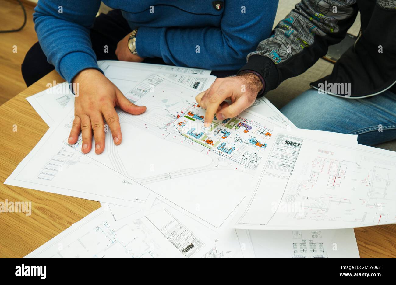 Partners working at building project on the office table Stock Photo ...