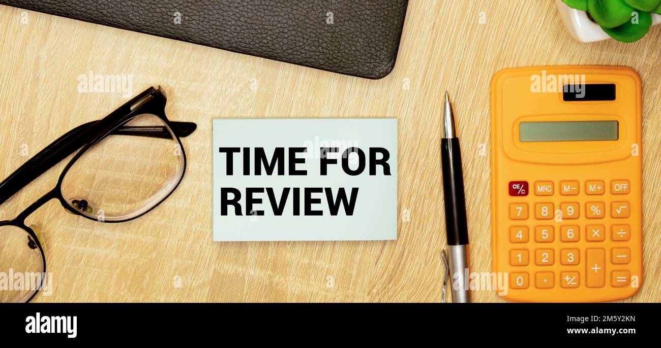 Businesswoman hands holding white card sign with time for Review text ...